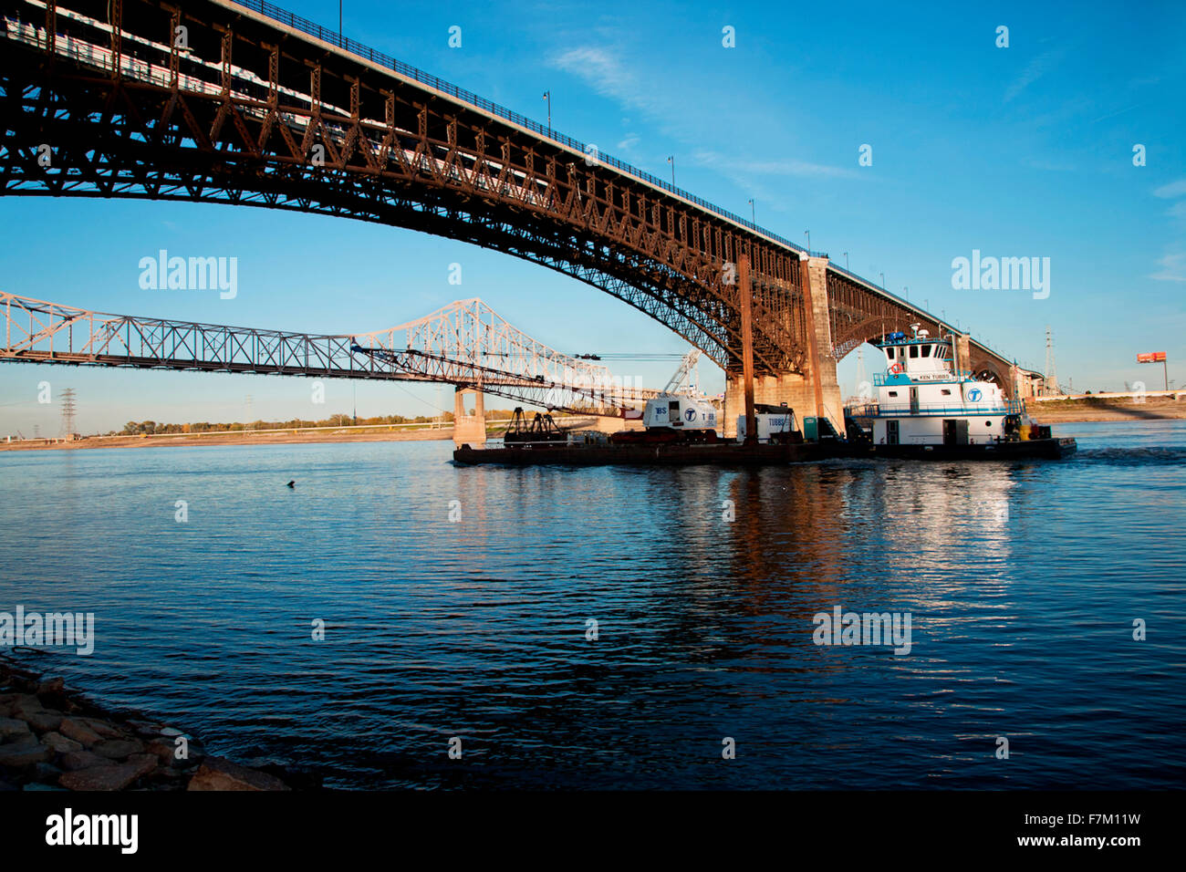 A river barge passes under the Eads Bridge on the Mississippi River, St ...