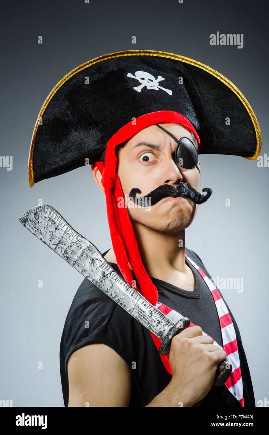 Funny pirate in the dark studio Stock Photo - Alamy