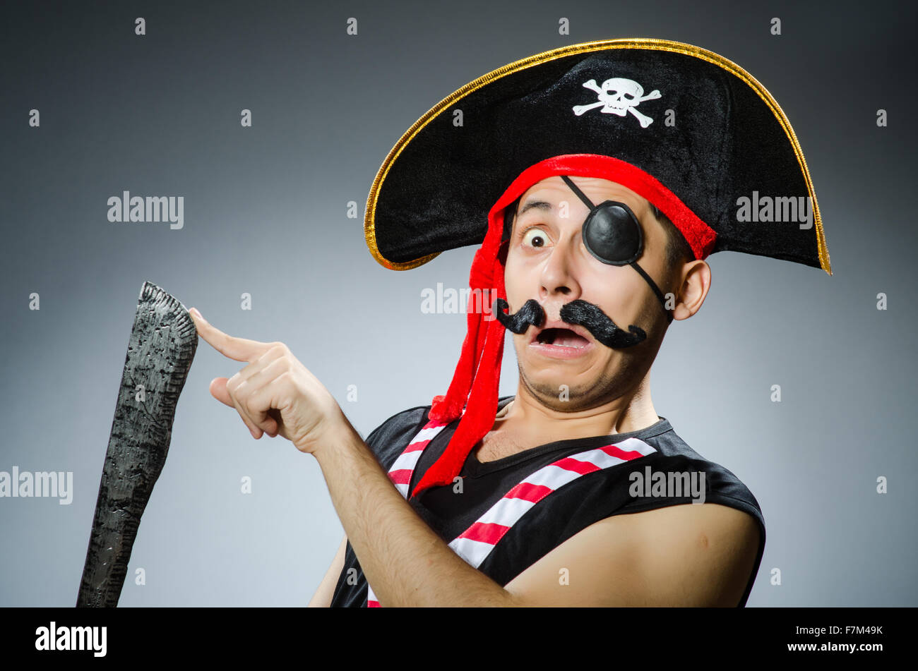 Funny pirate in the dark studio Stock Photo - Alamy