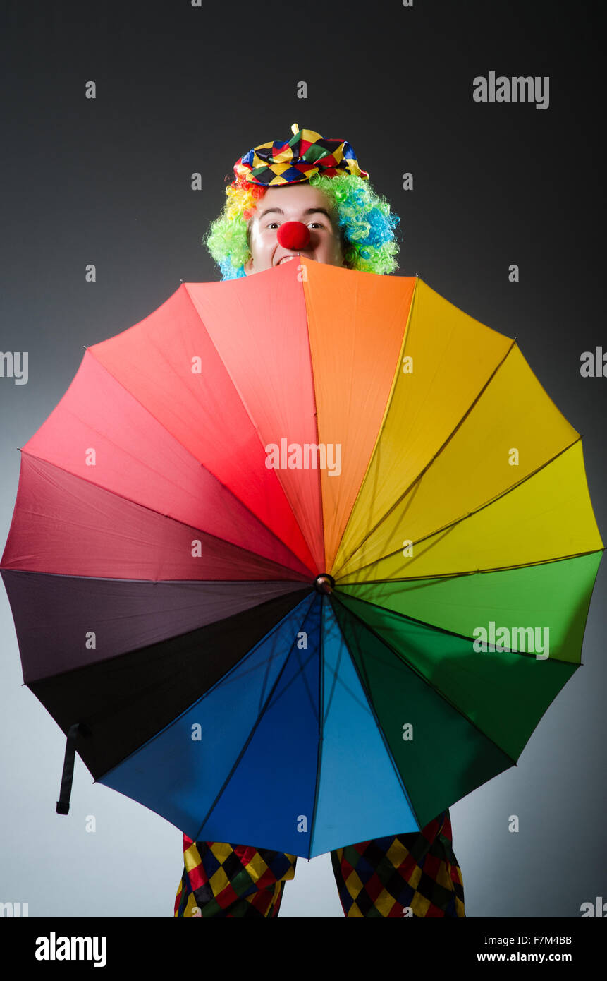 Funny clown with colourful umbrella Stock Photo - Alamy