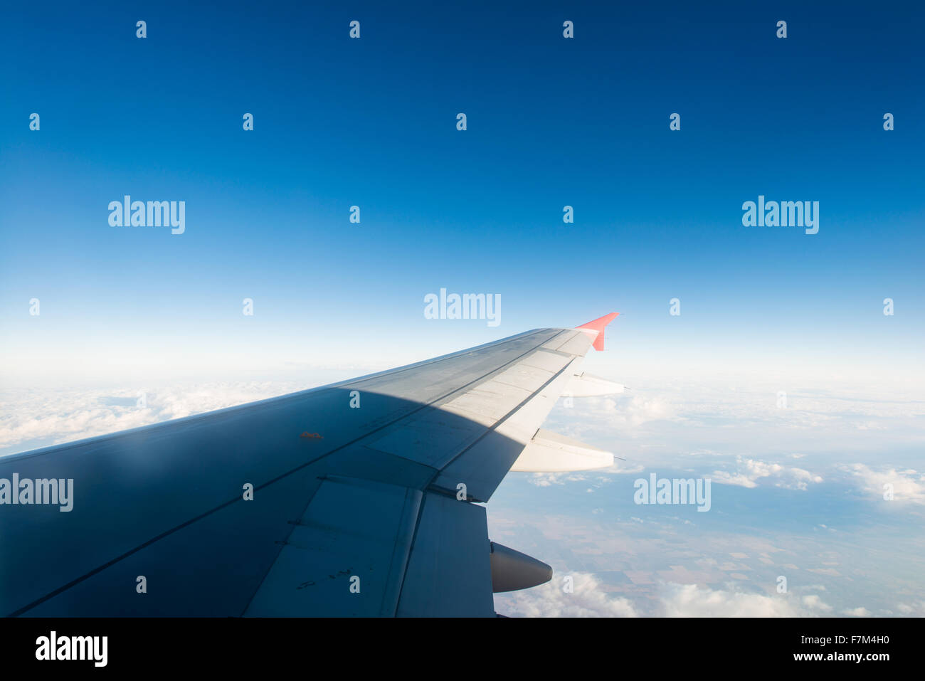 Airplane wing out of window Stock Photo - Alamy