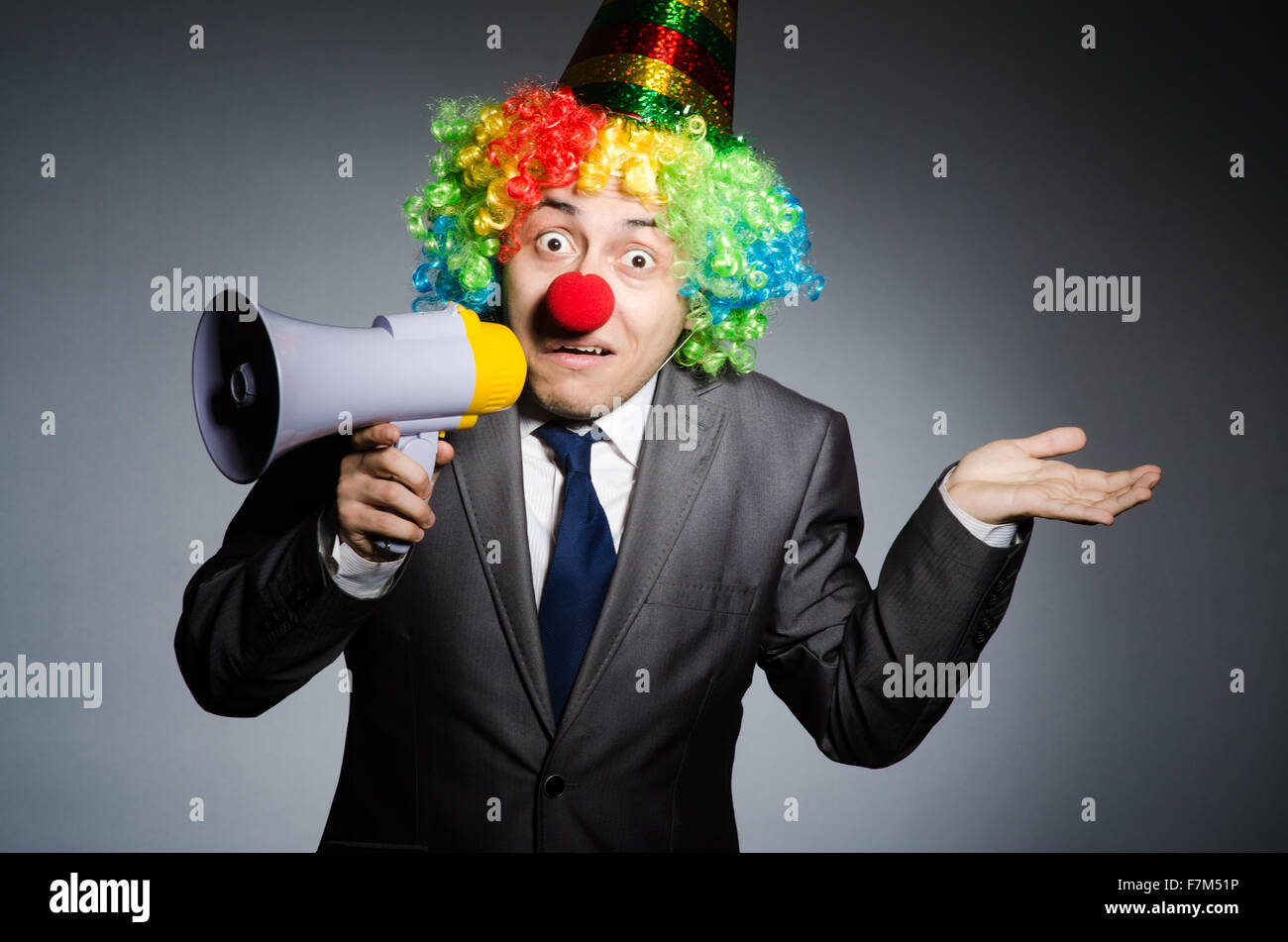 Clown with loudspeaker in funny concept Stock Photo - Alamy