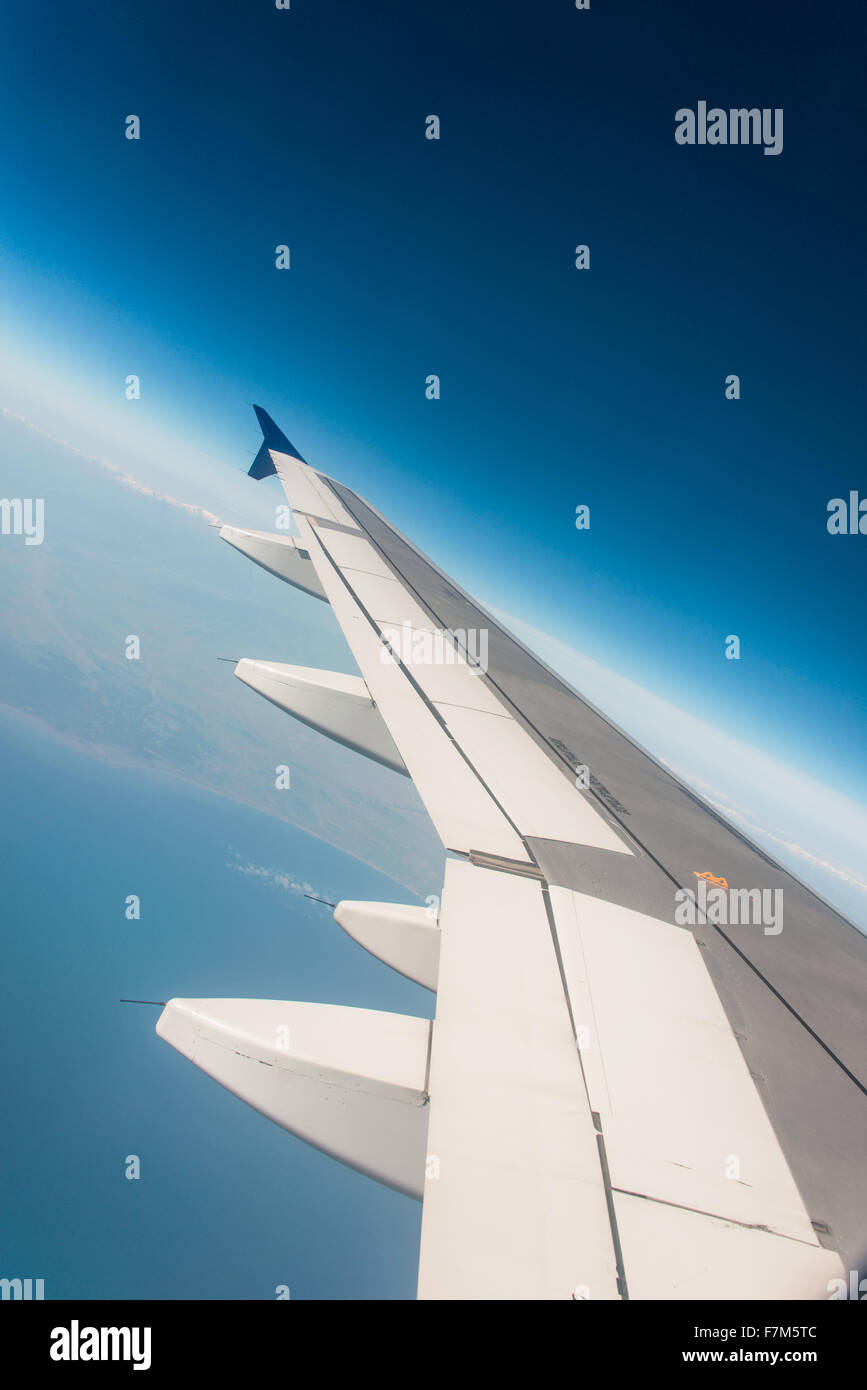 Airplane wing out of window Stock Photo - Alamy