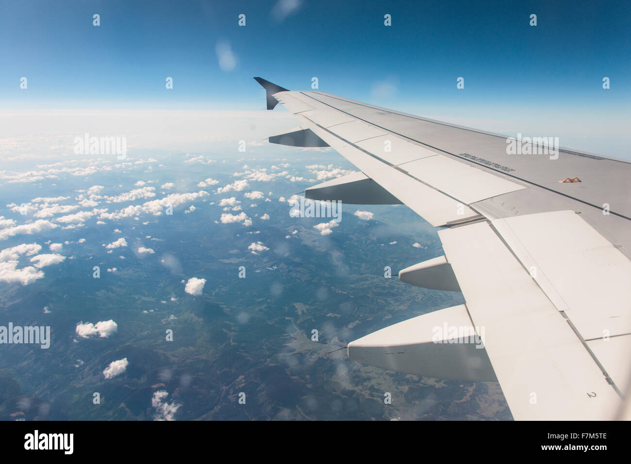 Airplane wing out of window Stock Photo - Alamy