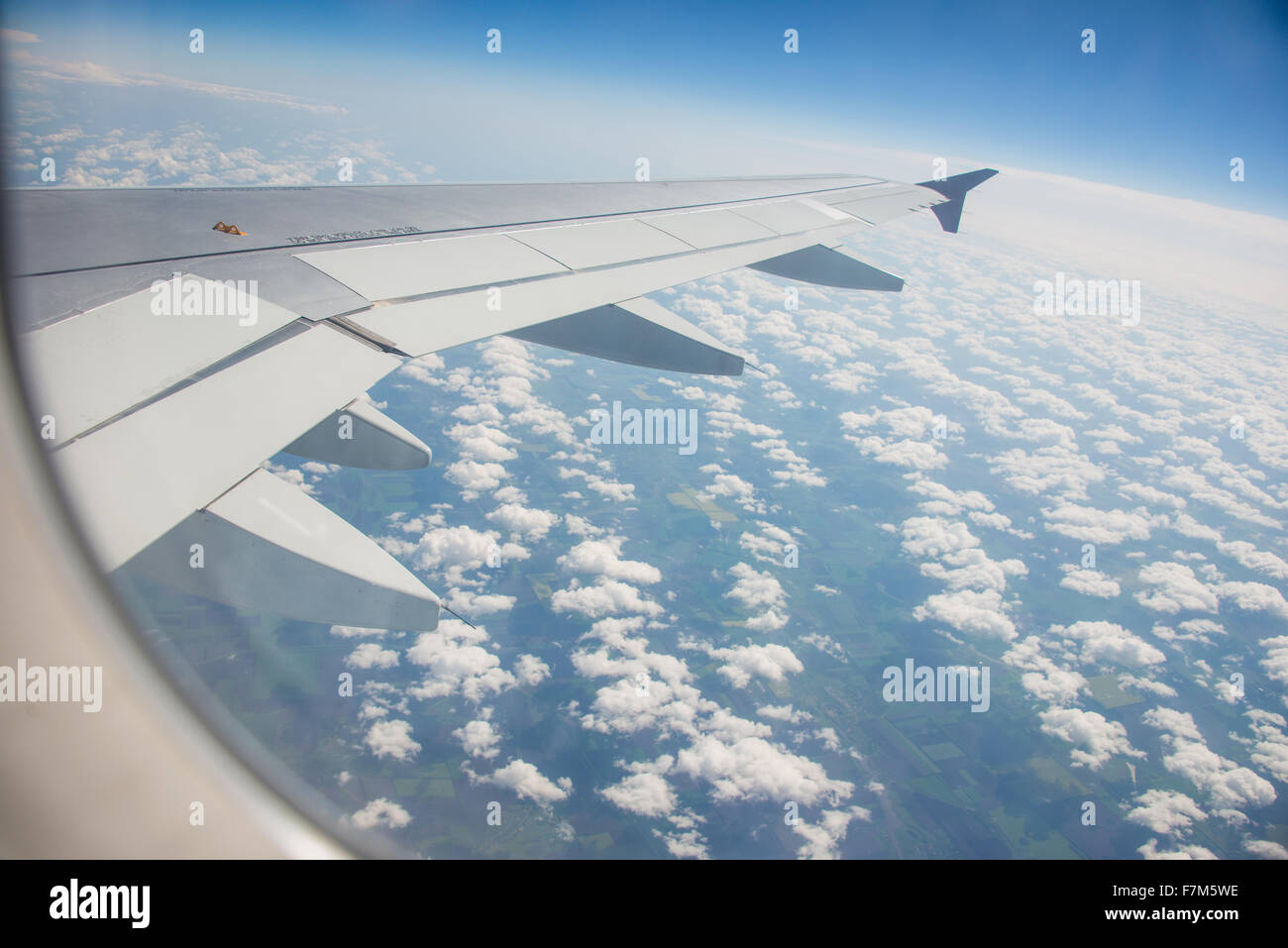 Airplane wing out of window Stock Photo - Alamy