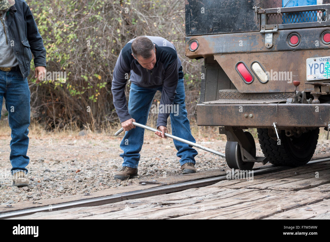 Aligning a high rail utility truck onto railroad tracks Stock Photo - Alamy