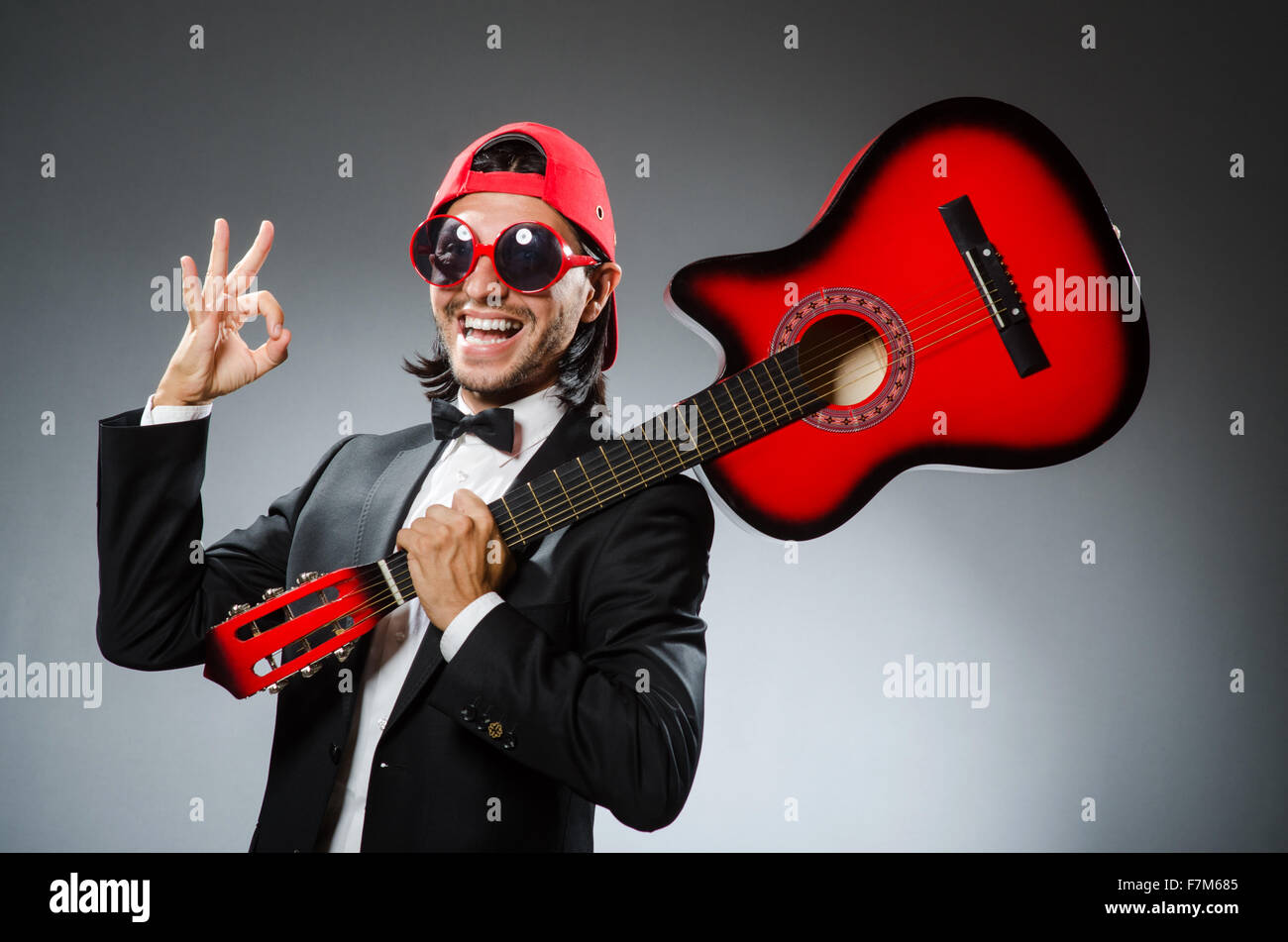Funny guitar player in studio Stock Photo - Alamy