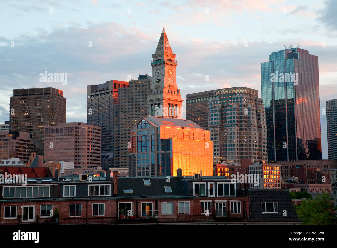 Sunset reflects in windows of Boston skyline and Commerce House Tower ...