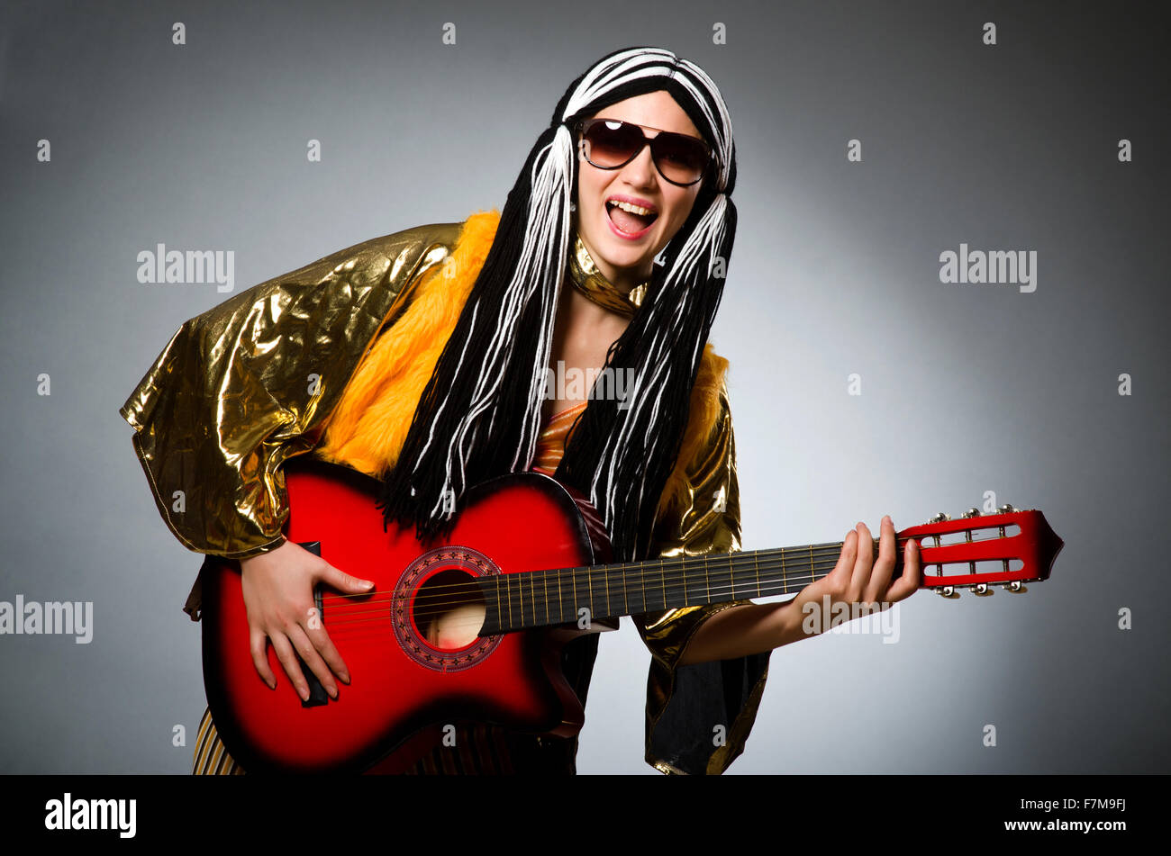 Guitar player with red instrument Stock Photo - Alamy