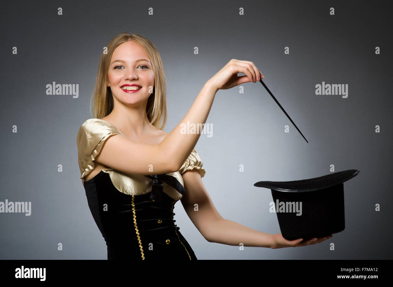Woman magician with magic wand and hat Stock Photo - Alamy