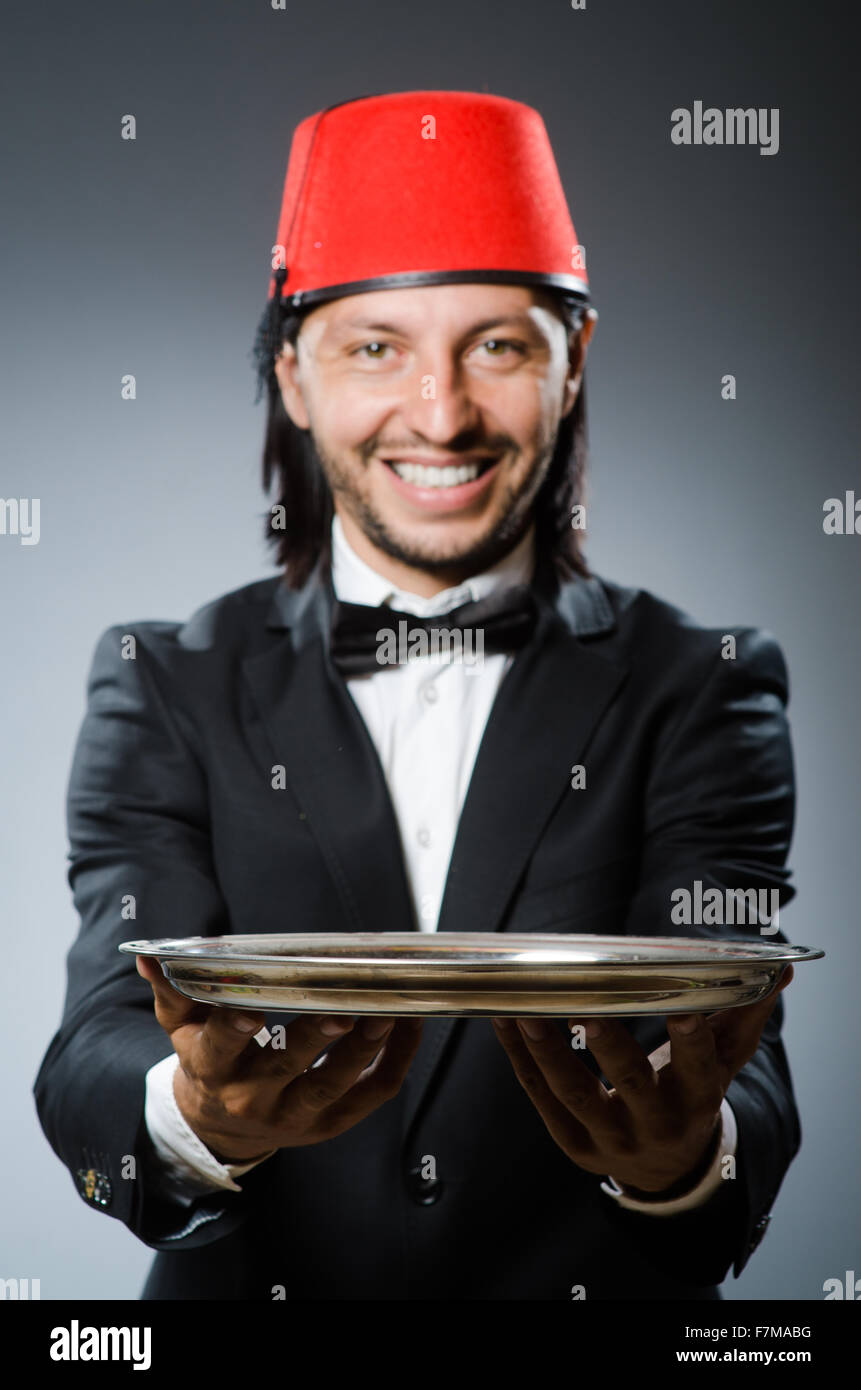 Waiter wearing traditional turkish hat Stock Photo - Alamy
