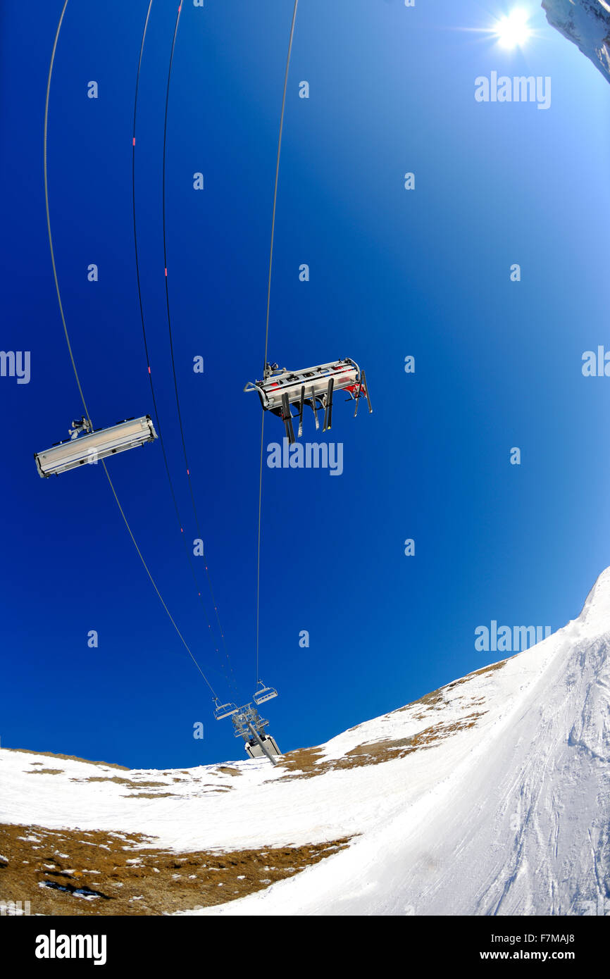 Ski lift - happy skiers use vertical transport on ski vacation at sunny ...