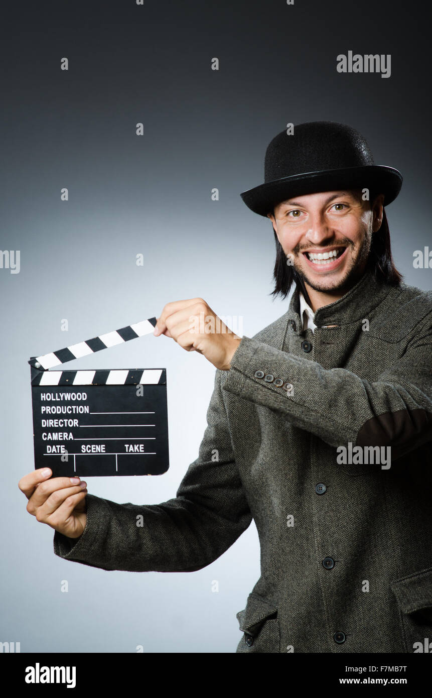 Man with movie clapperboard and hat Stock Photo - Alamy