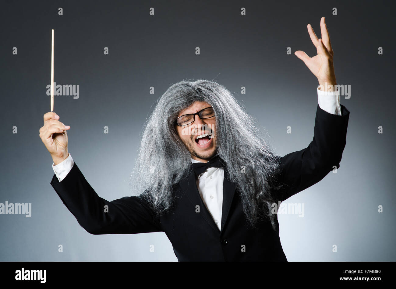 Funny conductor with long grey hair Stock Photo - Alamy