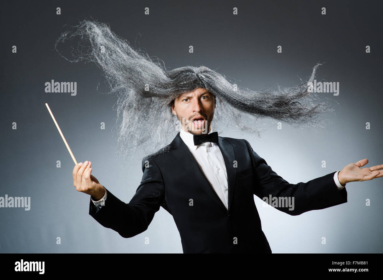 Funny conductor with long grey hair Stock Photo - Alamy