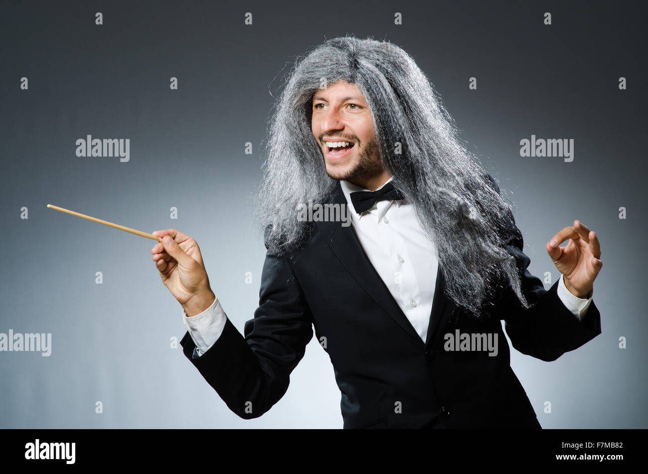 Funny conductor with long grey hair Stock Photo - Alamy