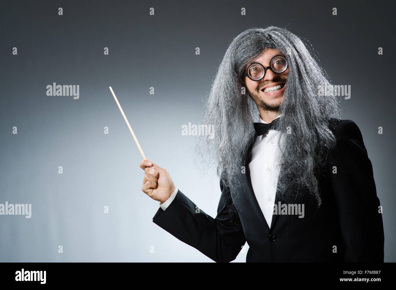 Funny conductor with long grey hair Stock Photo - Alamy