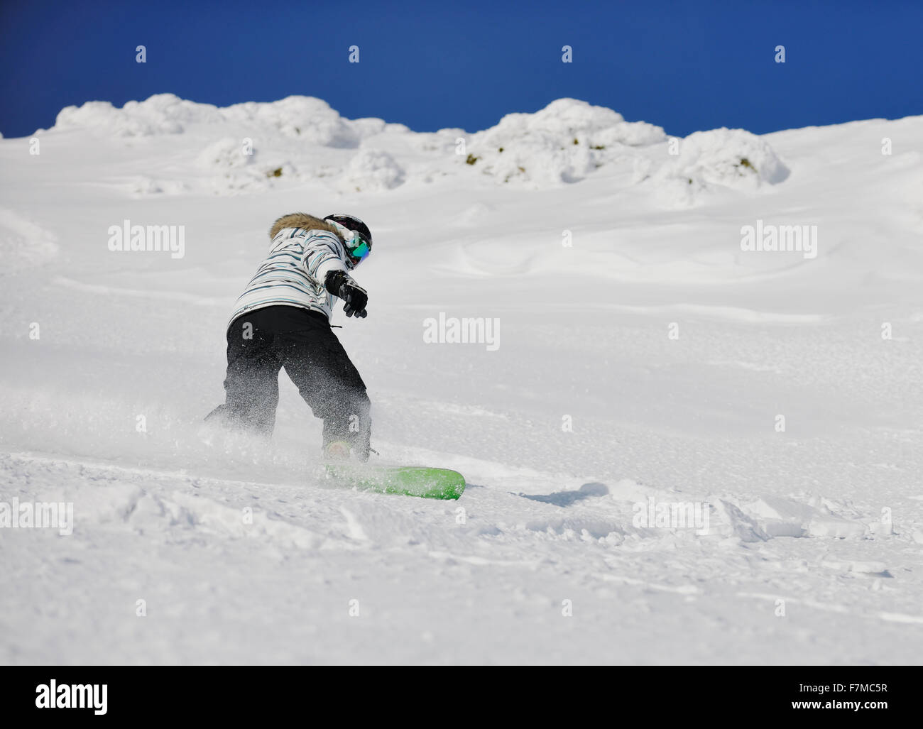 snowboard woman racing downhill slope and freeride on powder snow at ...
