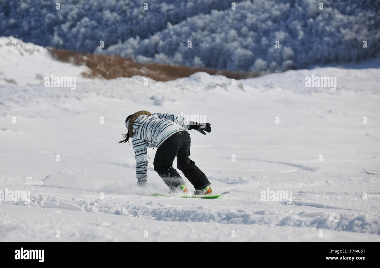 snowboard woman racing downhill slope and freeride on powder snow at ...