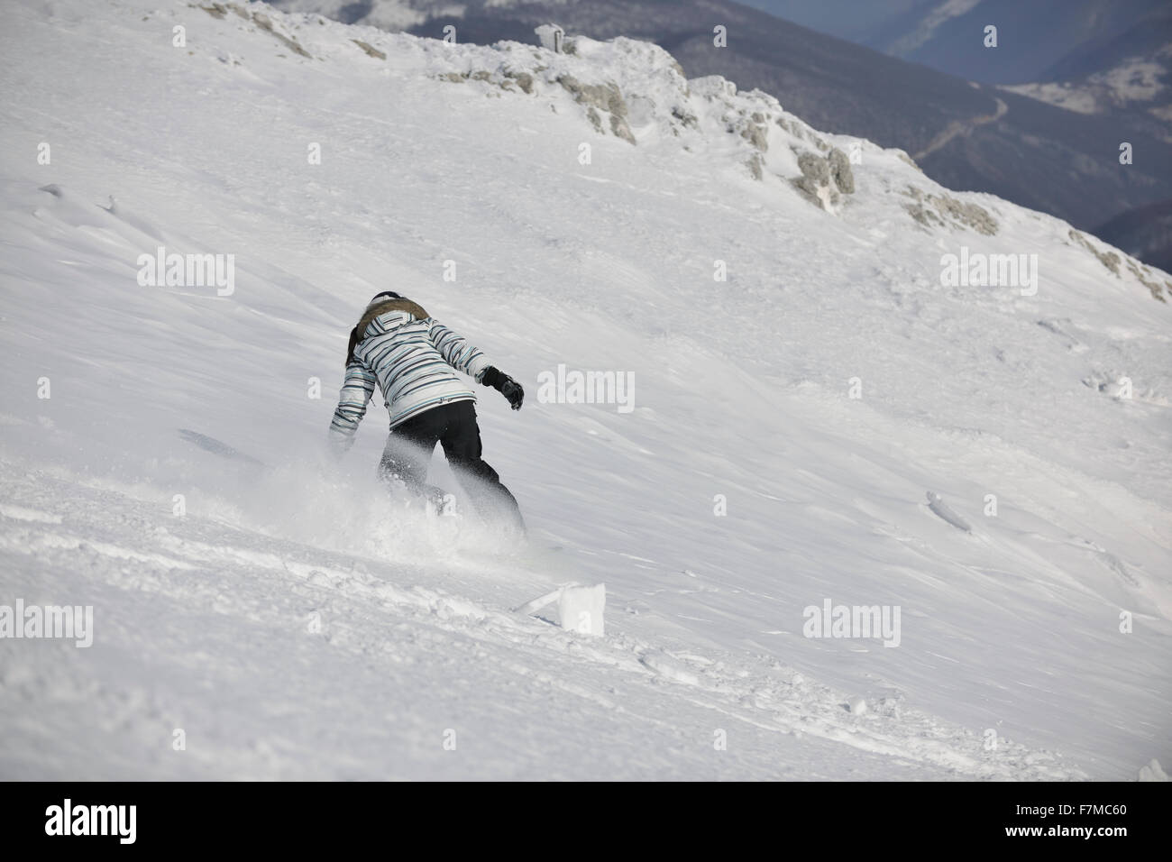 snowboard woman racing downhill slope and freeride on powder snow at ...