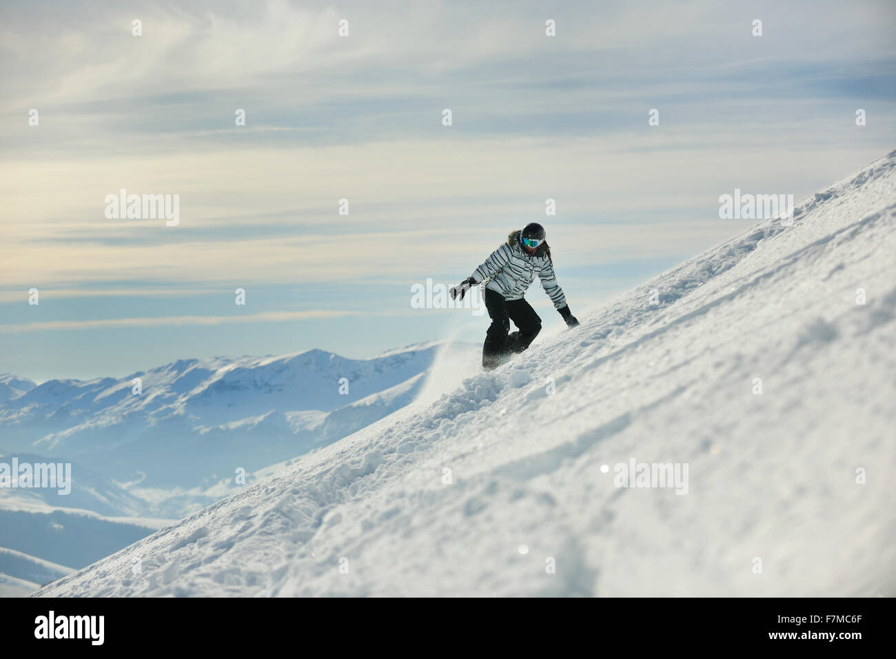 snowboard woman racing downhill slope and freeride on powder snow at ...