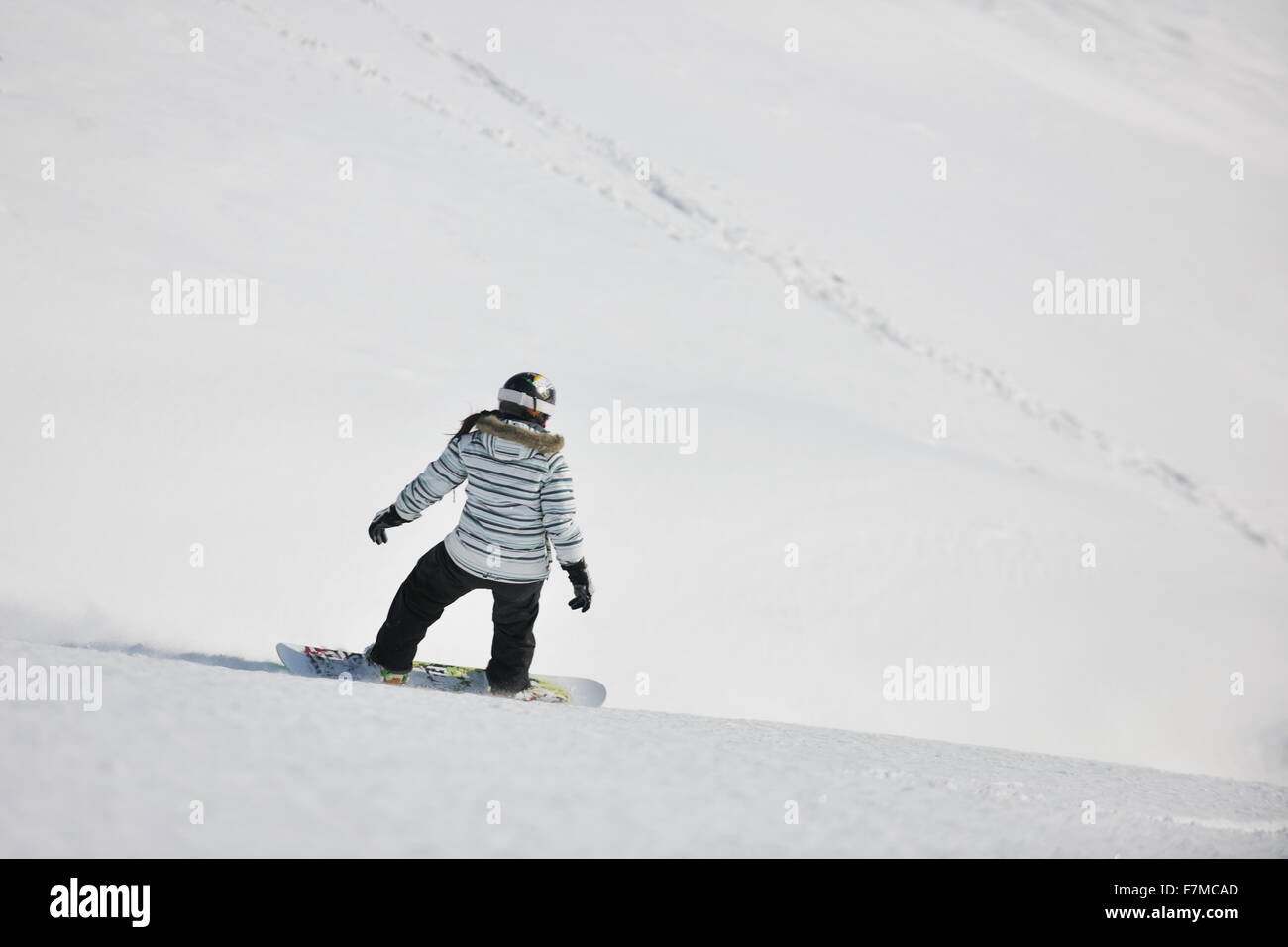 snowboard woman racing downhill slope and freeride on powder snow at ...