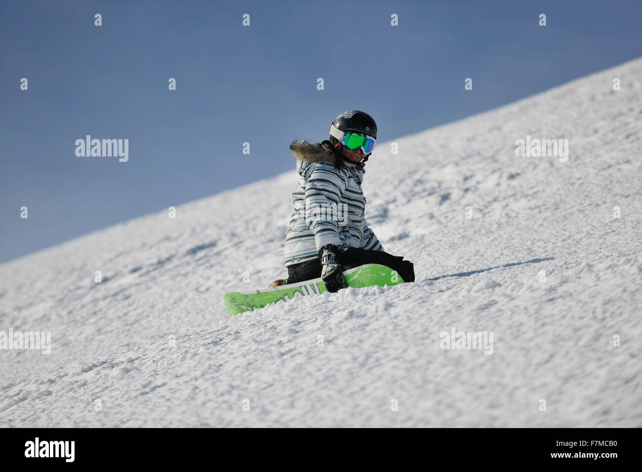 snowboard woman racing downhill slope and freeride on powder snow at ...