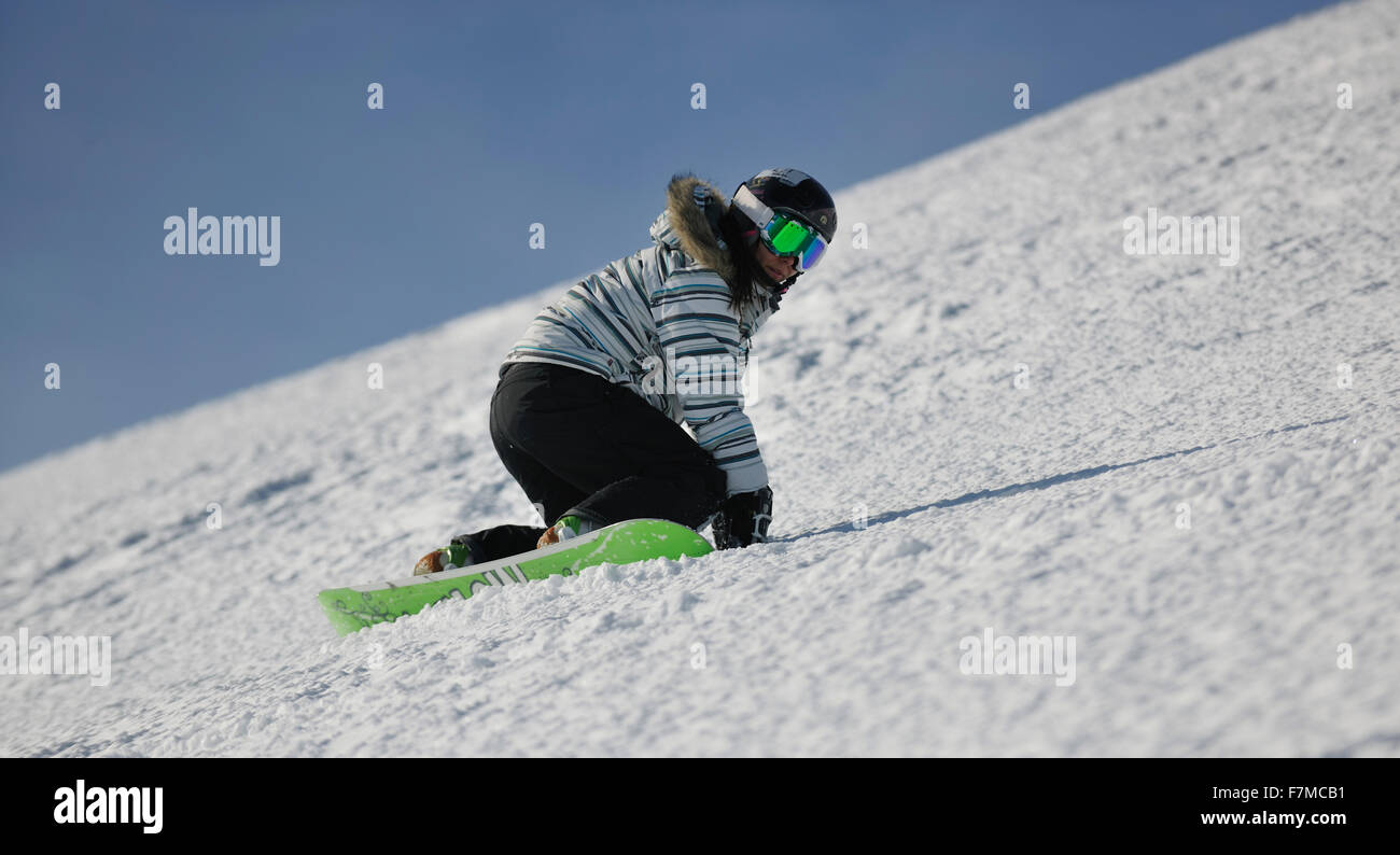 snowboard woman racing downhill slope and freeride on powder snow at ...