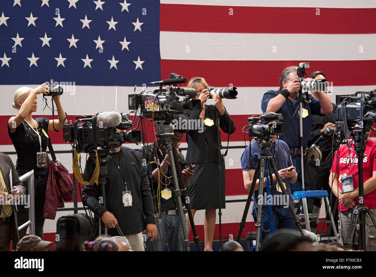 National Press and TV cameramen stand in front of a large US Flag are ...