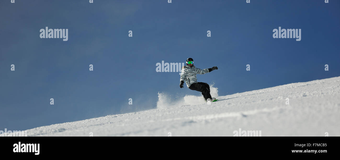 snowboard woman racing downhill slope and freeride on powder snow at ...