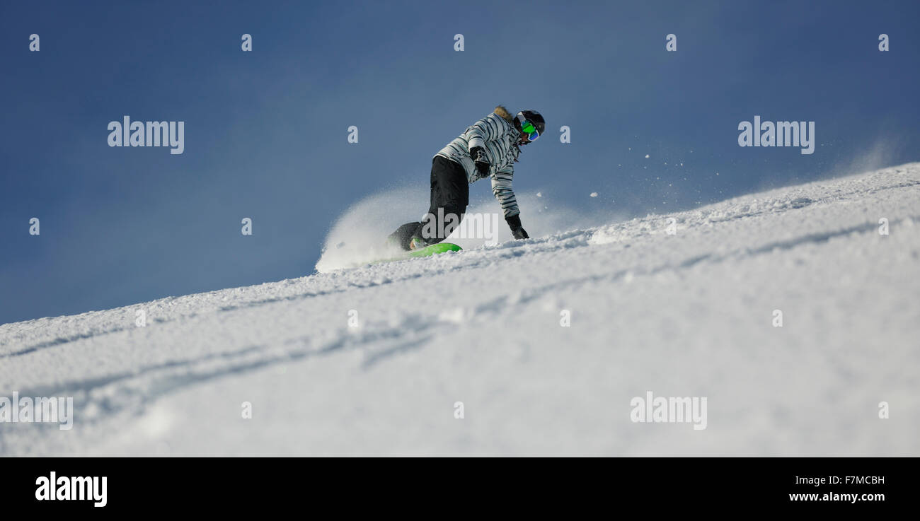 snowboard woman racing downhill slope and freeride on powder snow at ...