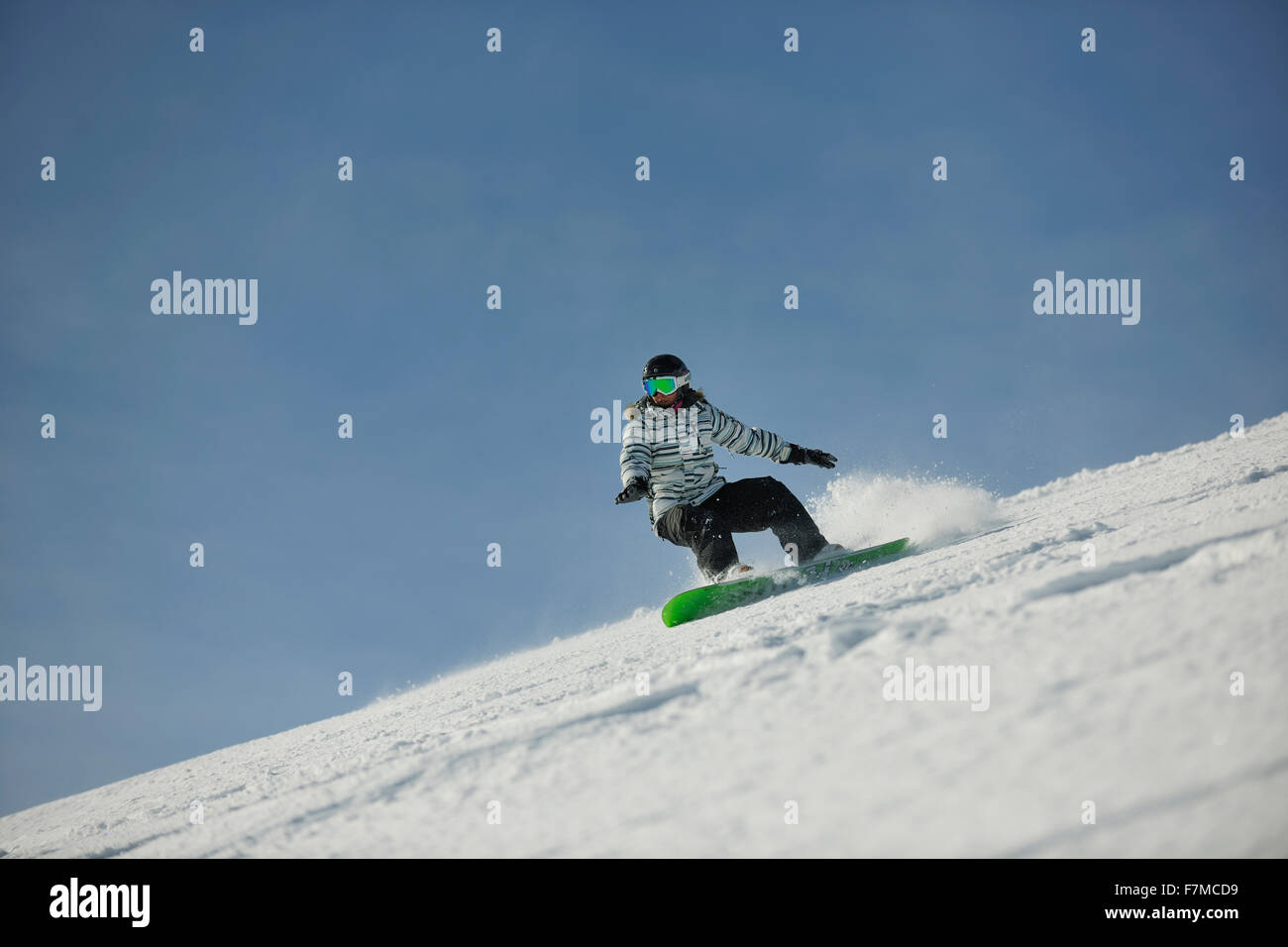 snowboard woman racing downhill slope and freeride on powder snow at ...