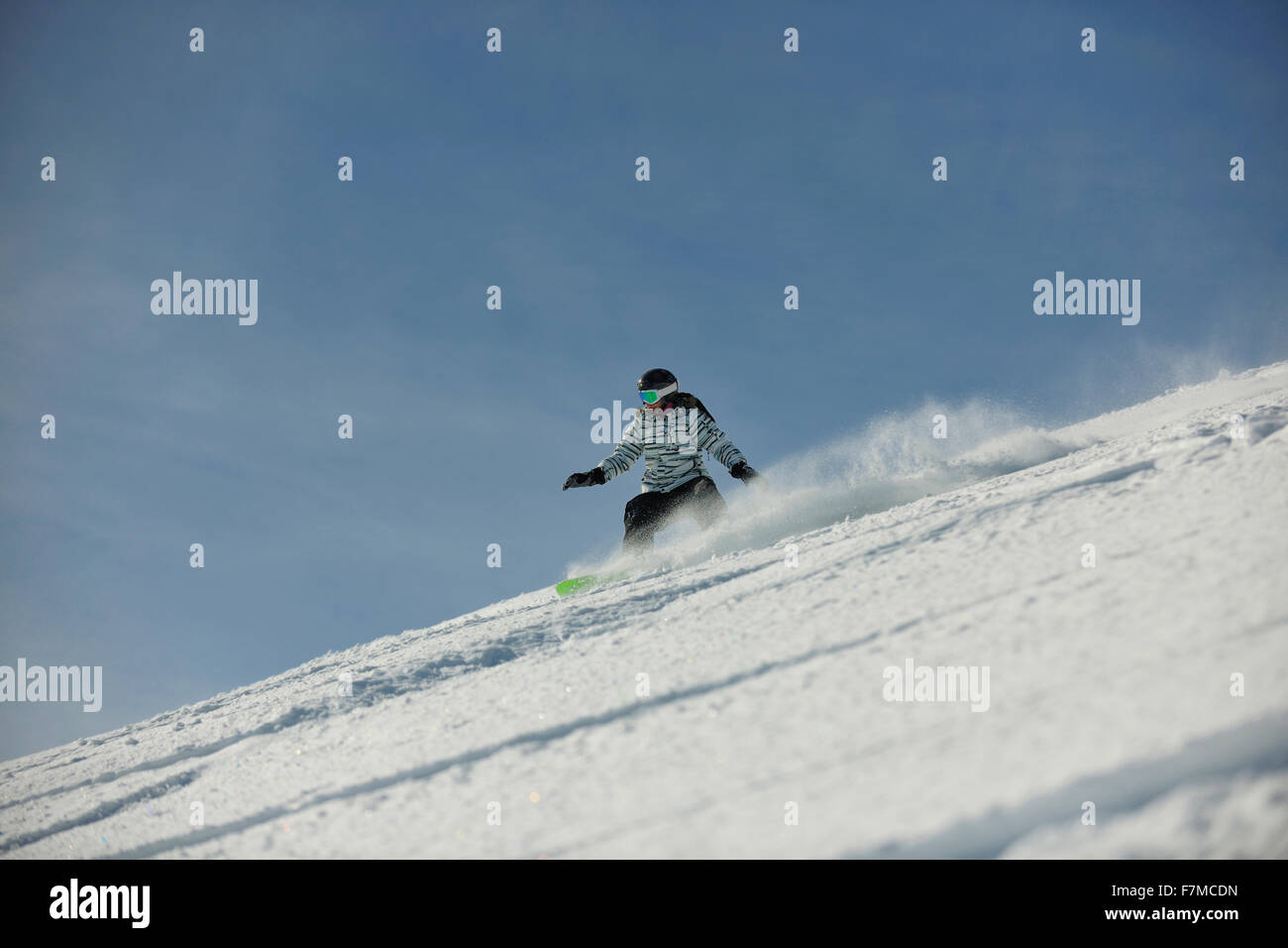 snowboard woman racing downhill slope and freeride on powder snow at ...