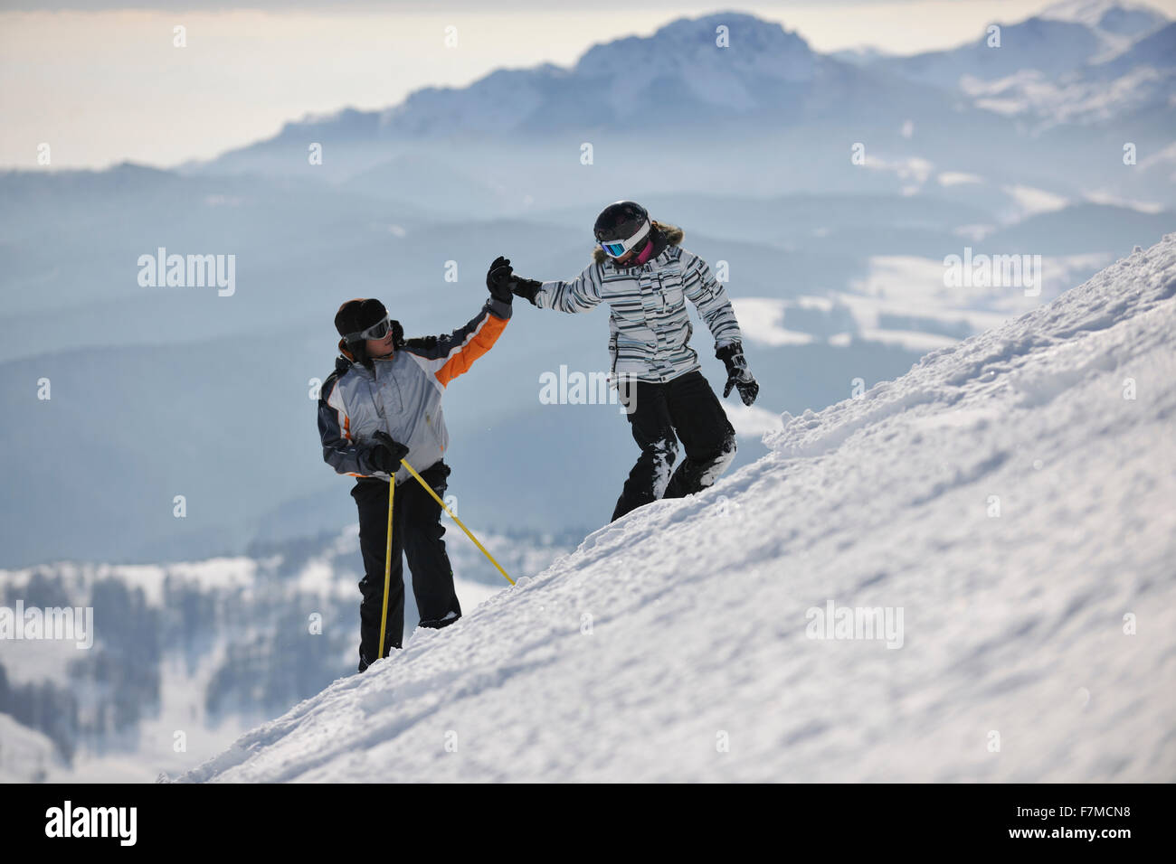 happy couple drivingand relaxing with snowboard and ski at winter ...