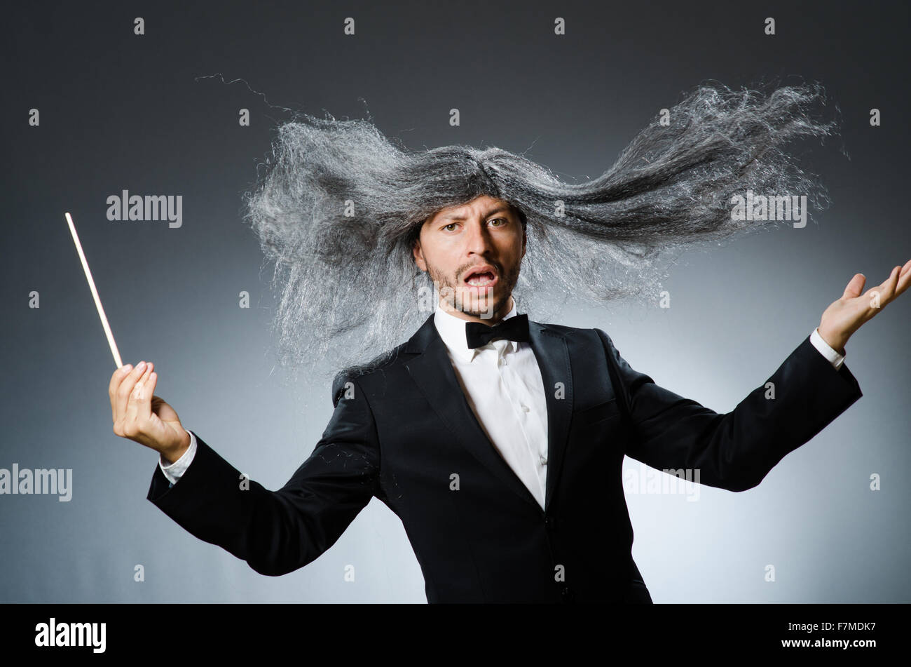 Funny conductor with long grey hair Stock Photo - Alamy