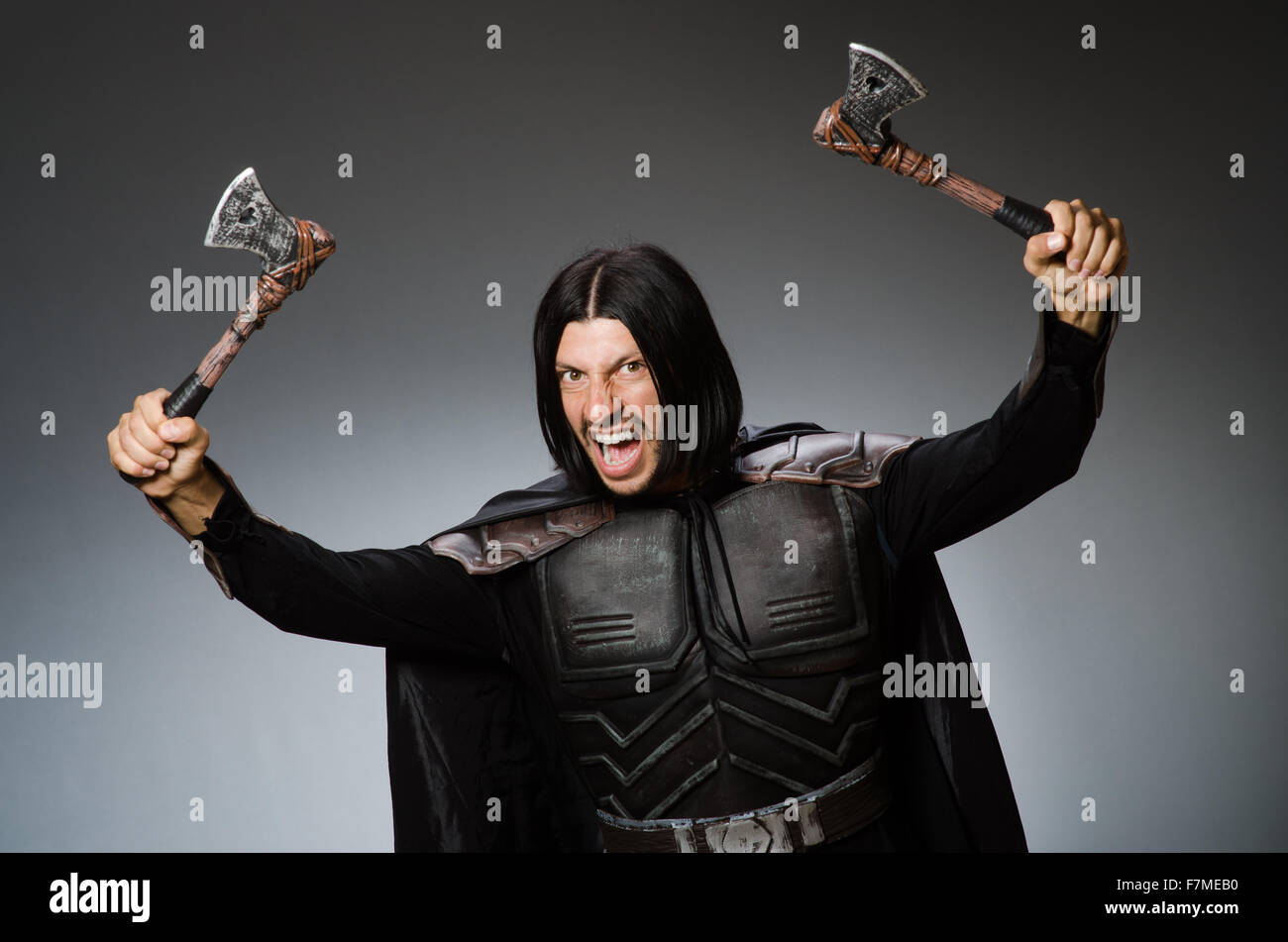 Knight with axe against dark background Stock Photo - Alamy