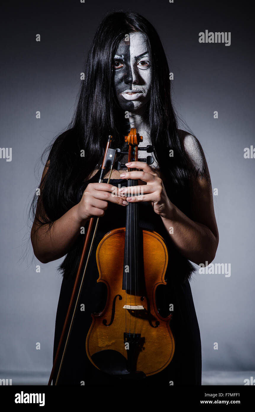 Scary monster playing violing in halloween concept Stock Photo - Alamy