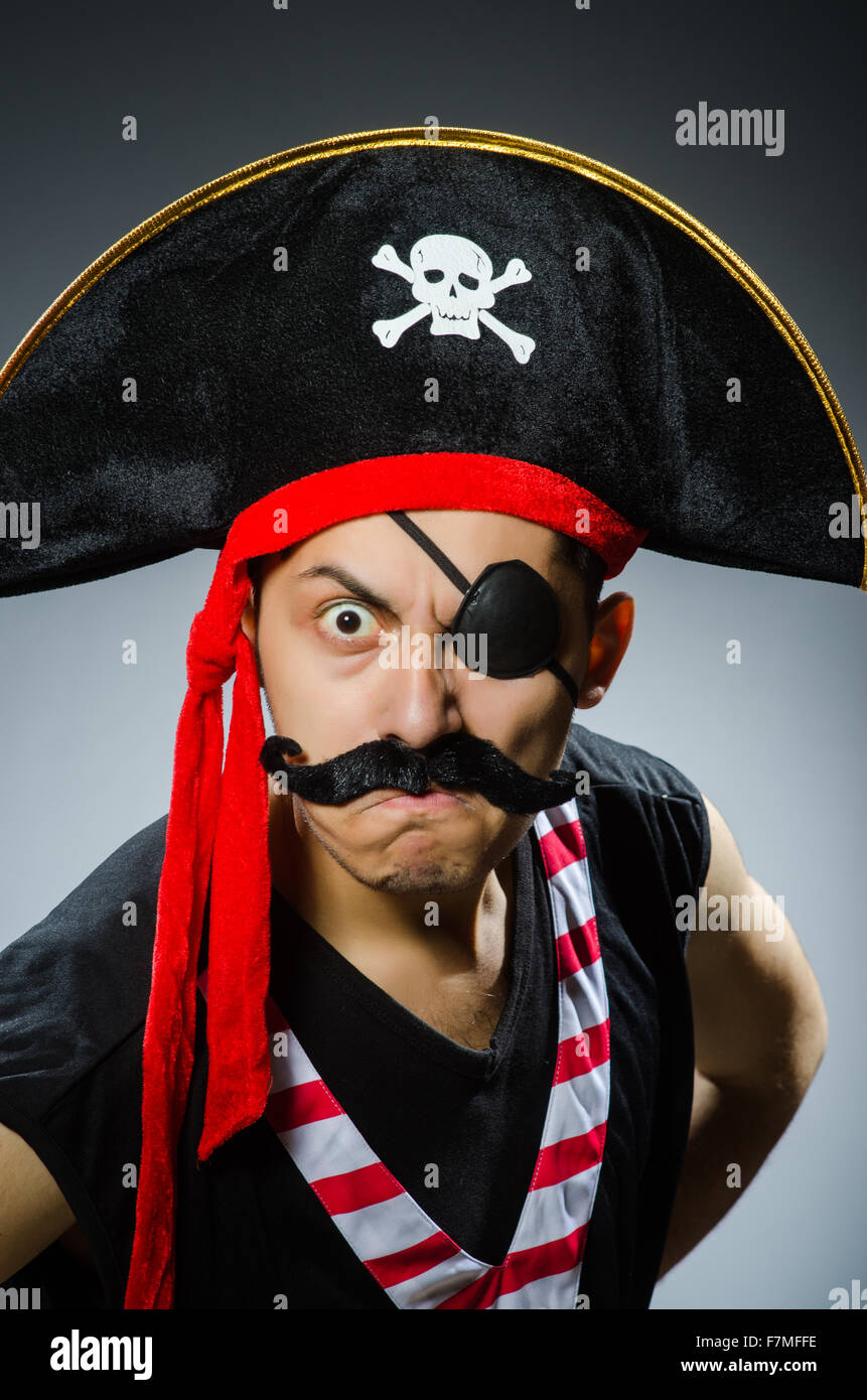 Funny pirate in the dark studio Stock Photo - Alamy