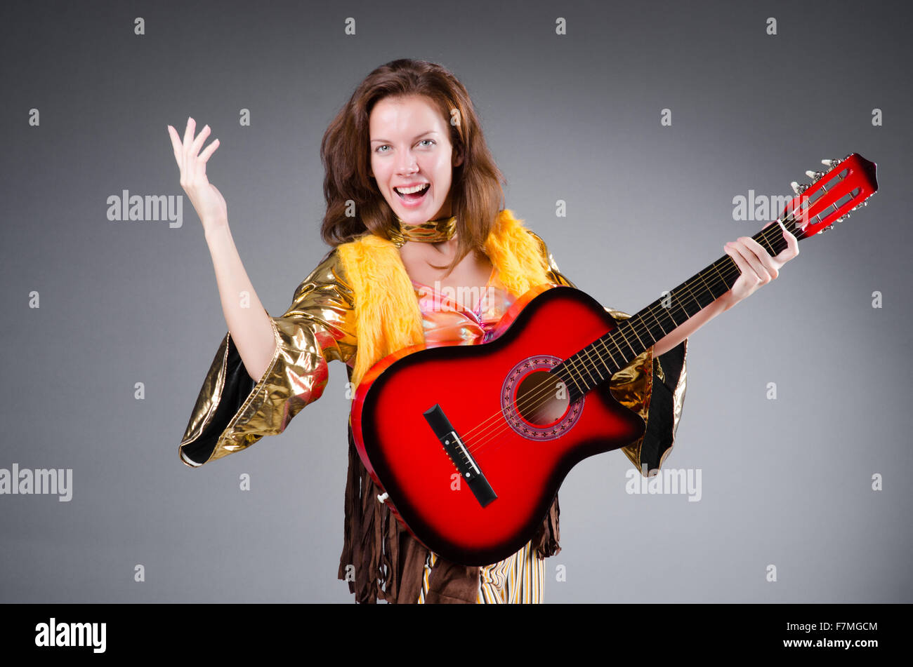 Guitar player with red instrument Stock Photo - Alamy