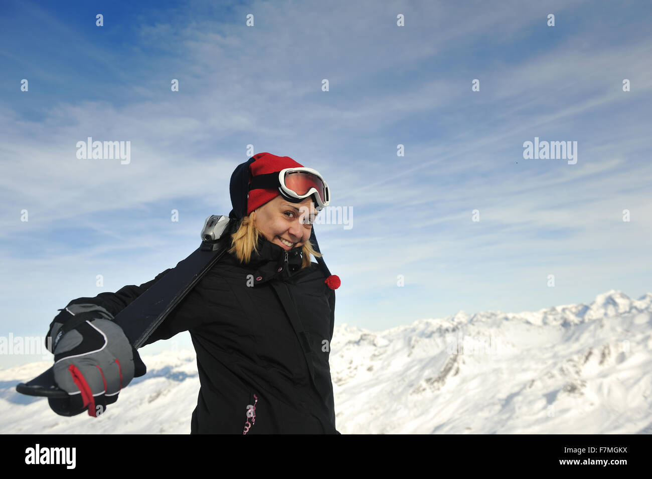 happy young woman have fan while relaxing at snow with ski and ...