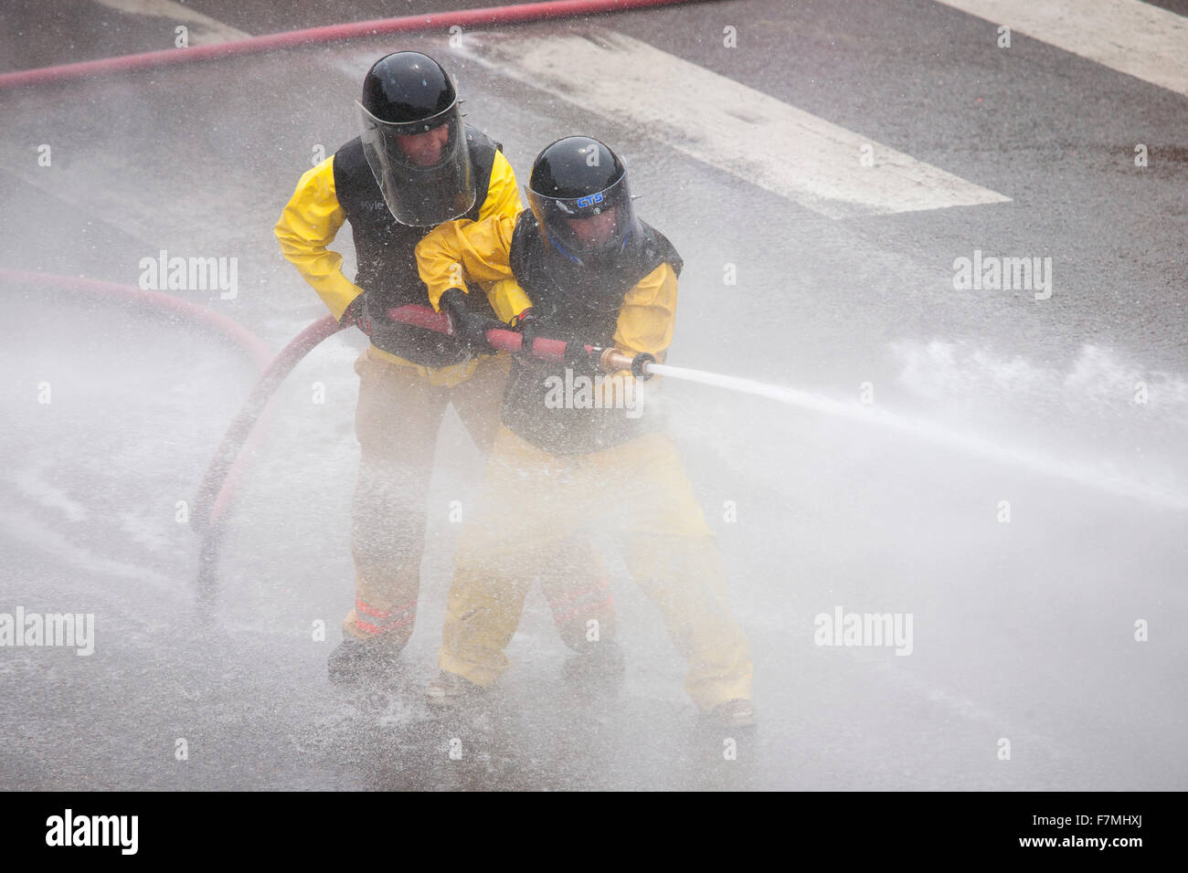 Men dressed in yellow firemen slickers and firehoses have annual ...