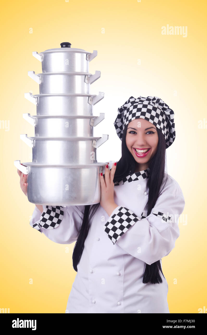 Cook with stack of pots on white Stock Photo - Alamy