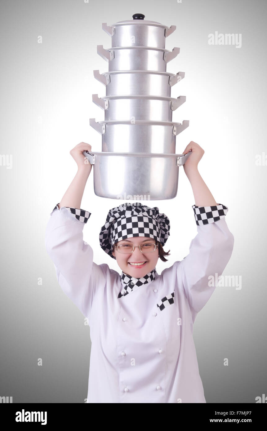 Cook with stack of pots on white Stock Photo - Alamy