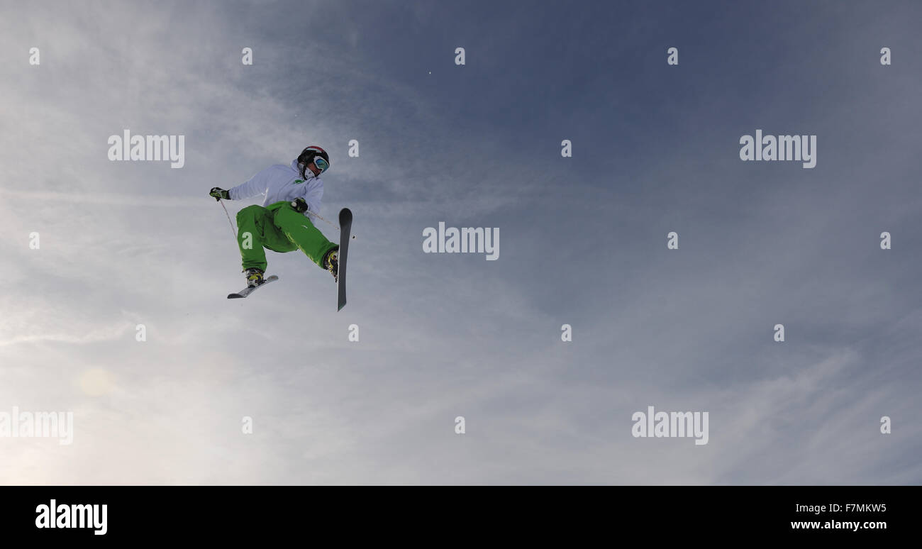 extreme freestyle ski jump with young man at mountain in snow park at ...