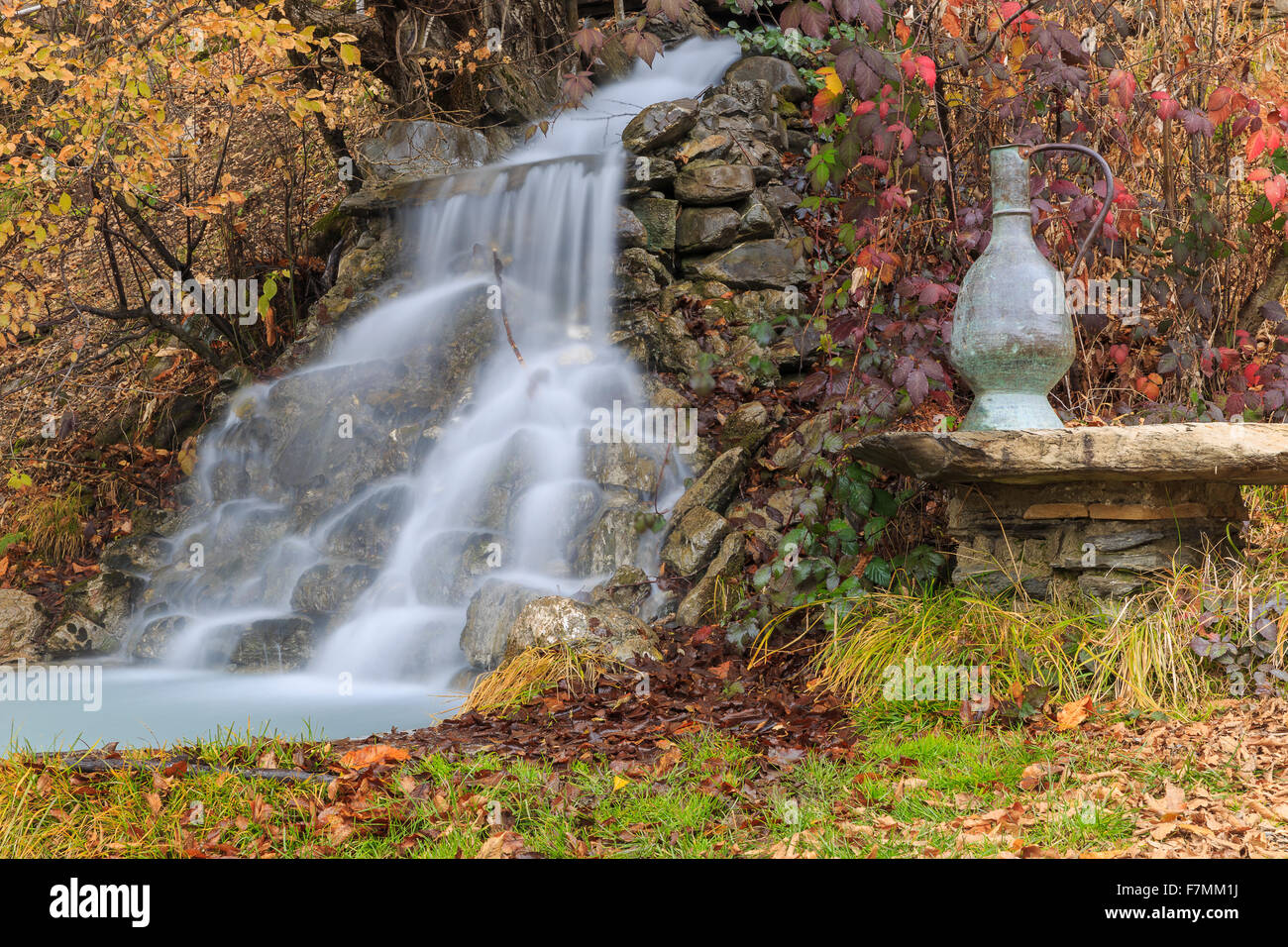 Waterfall and the ancient vessel for water transfer.Village Vandam ...