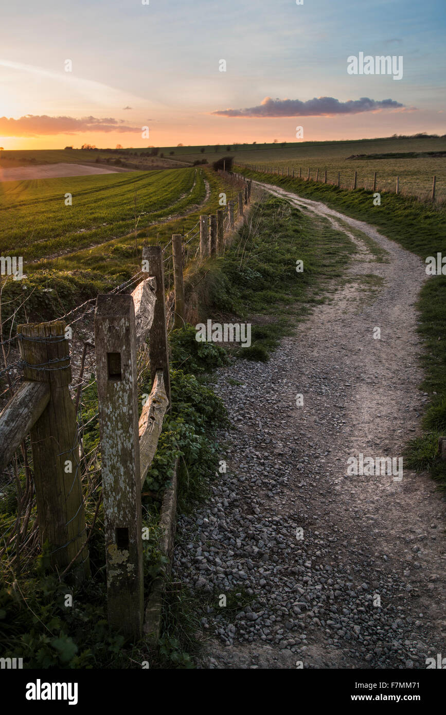 Beautiful Spring landscape of gate leading into fields with setting sun ...