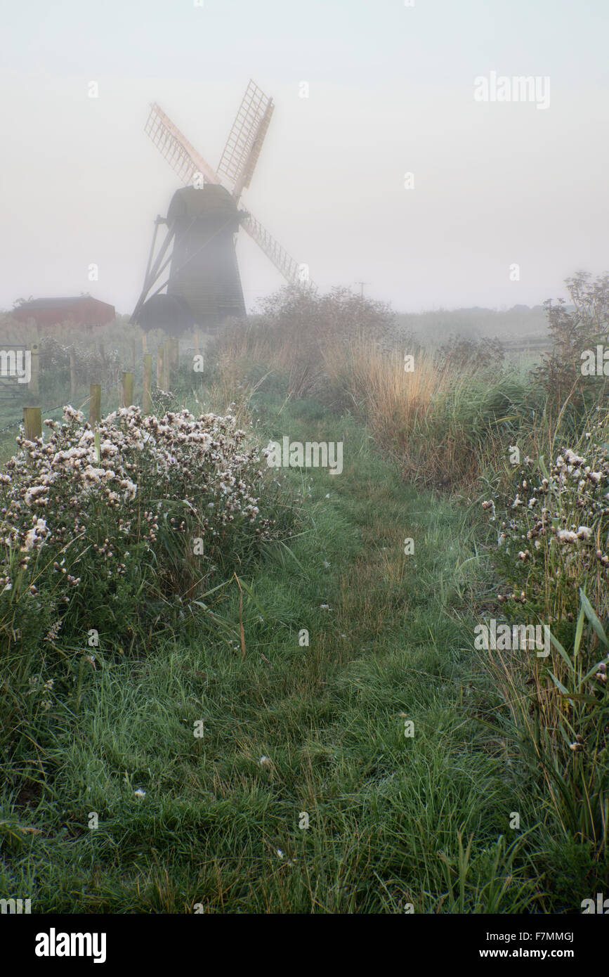 Old windmill in foggy English countryside landscape Stock Photo - Alamy