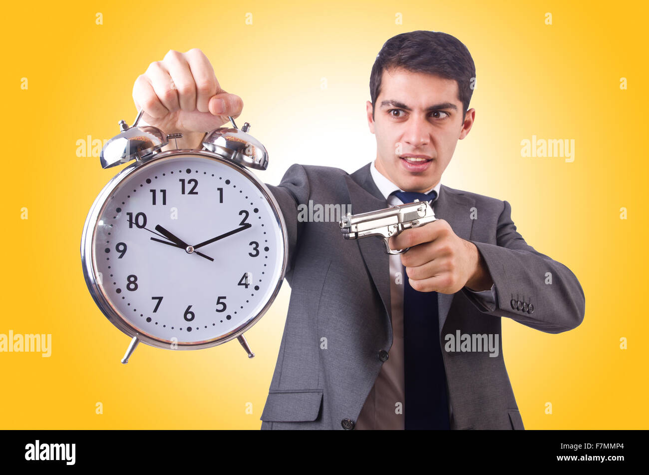 Man with gun and clock on white Stock Photo - Alamy