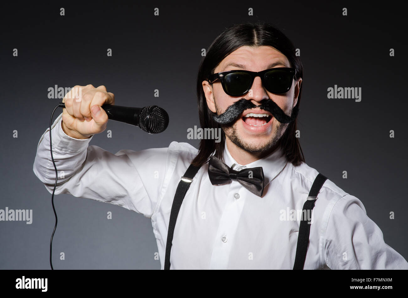 Funny singer with microphone at the concert Stock Photo - Alamy