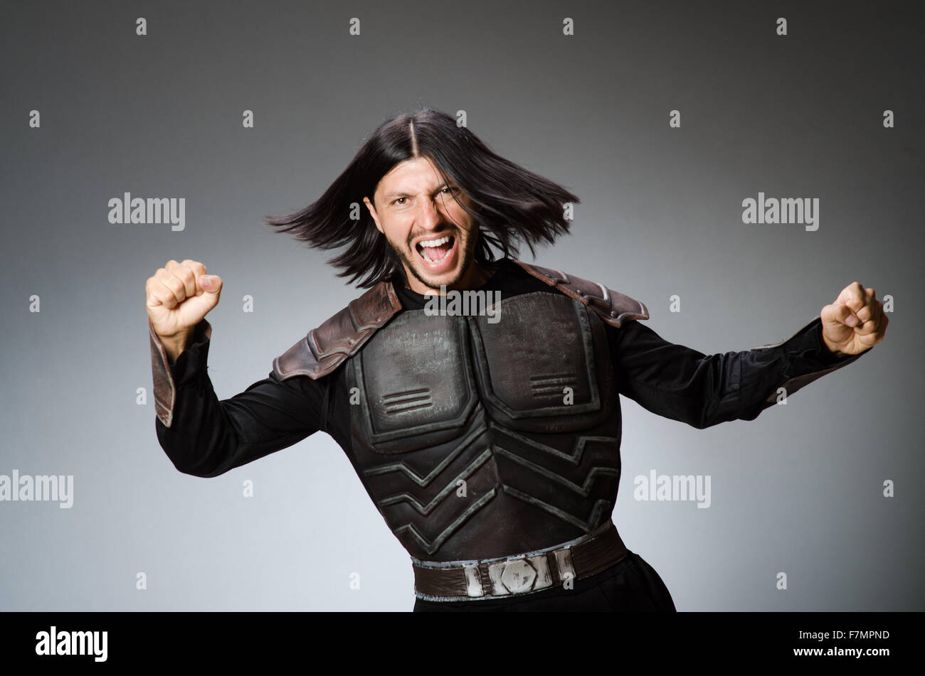 Angry warrior against dark background Stock Photo - Alamy